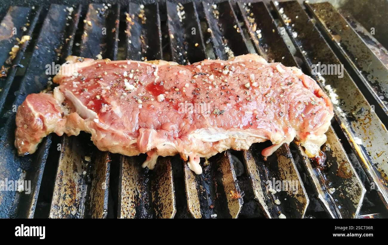 BBQ beef roasting on a metal grill Stock Photo - Alamy