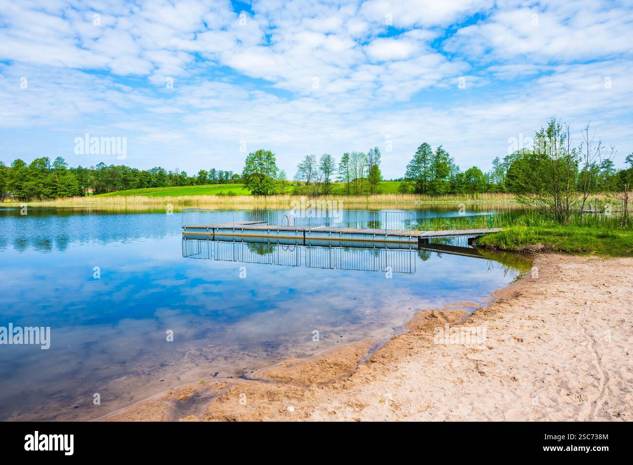 Wooden pier and beach on shore of Pobondzie lake, Suwalski Landscape ...