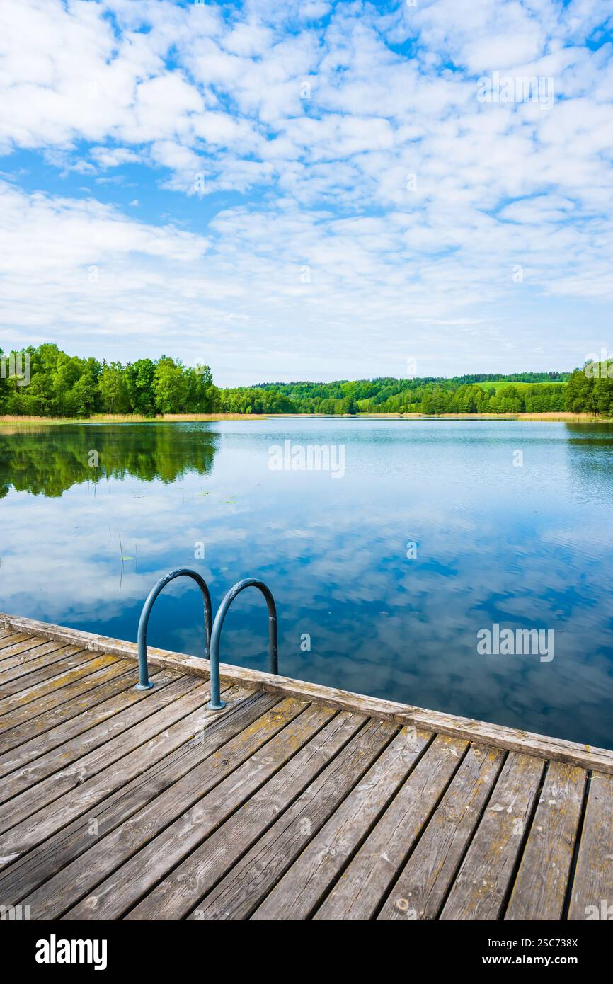 Wooden pier on shore of Pobondzie lake in spring season, Suwalski ...