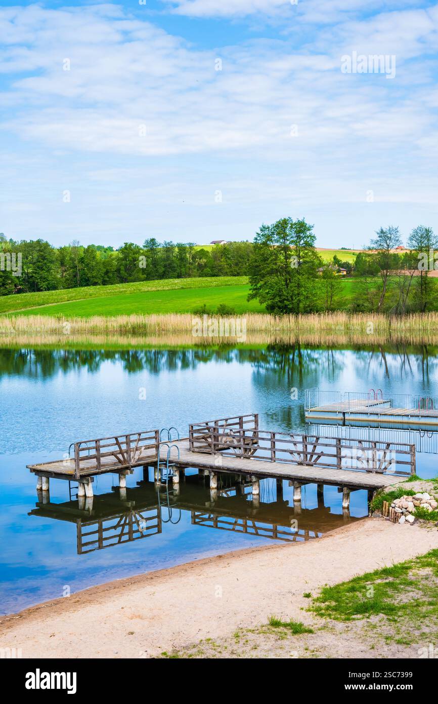 Wooden pier and beach on shore of Pobondzie lake, Suwalski Landscape ...