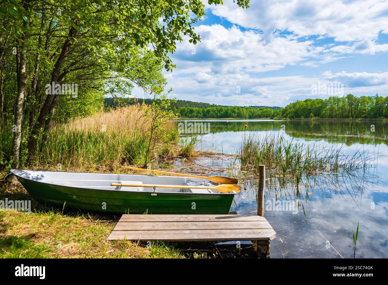 Fishing boat anchoring by wooden pier at beautiful lake, Suwalski ...