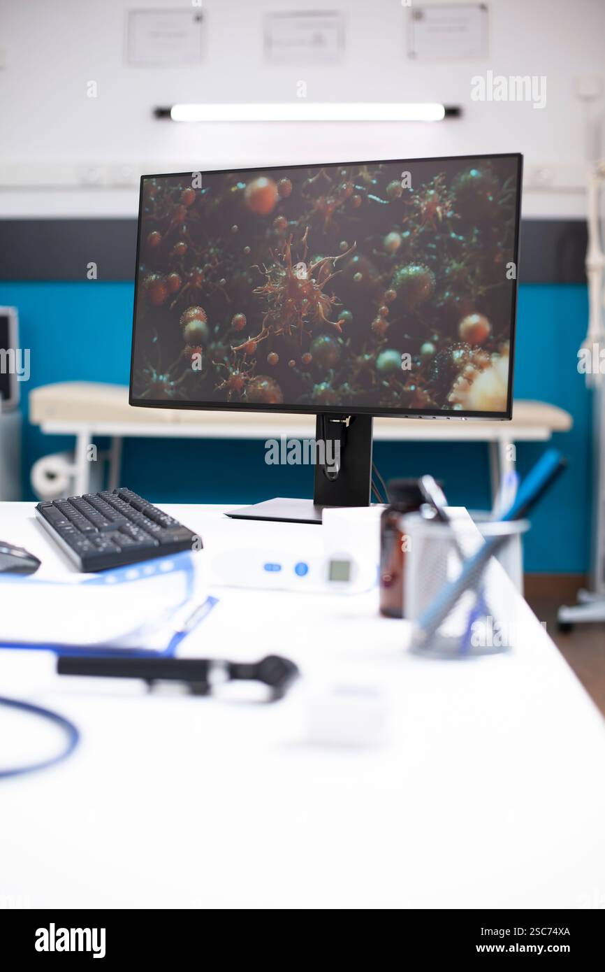Digital screen in vacant hospital room displaying microscopic germs and ...
