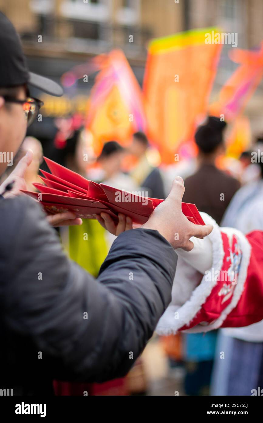 young asian man receives traditional red envelopes at the chinese new ...