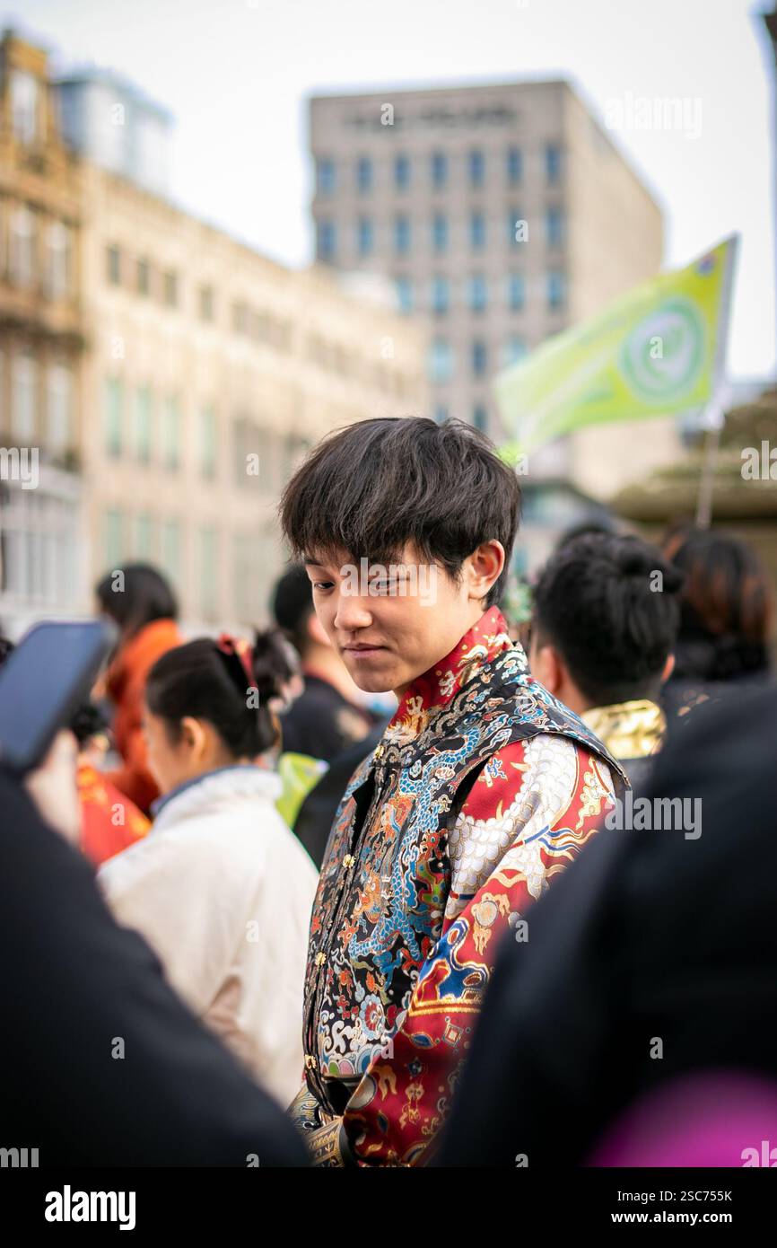 young asian man in traditional dress at the chinese new year parade ...