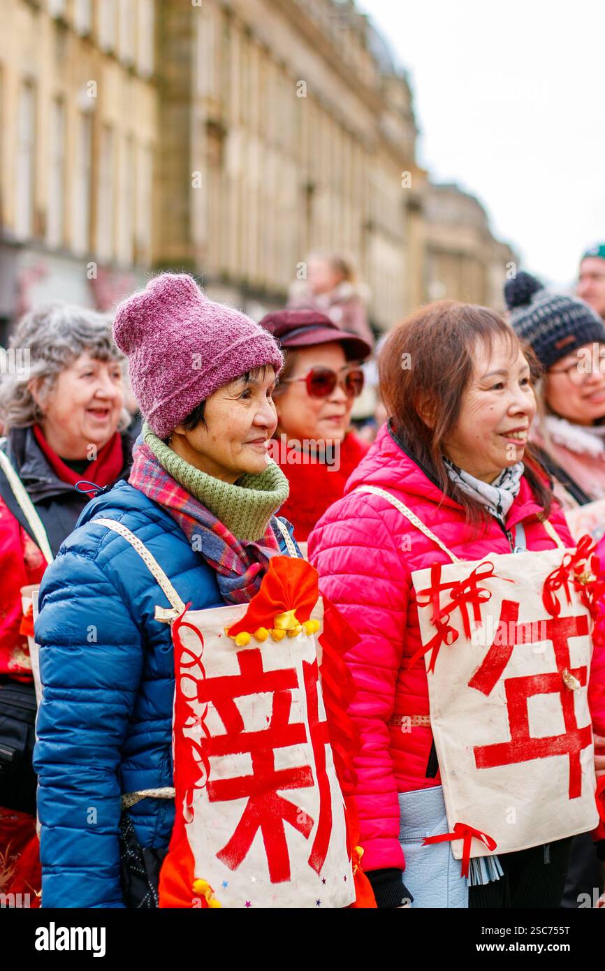 two older senior women wearing banners at the chinese new year parade ...
