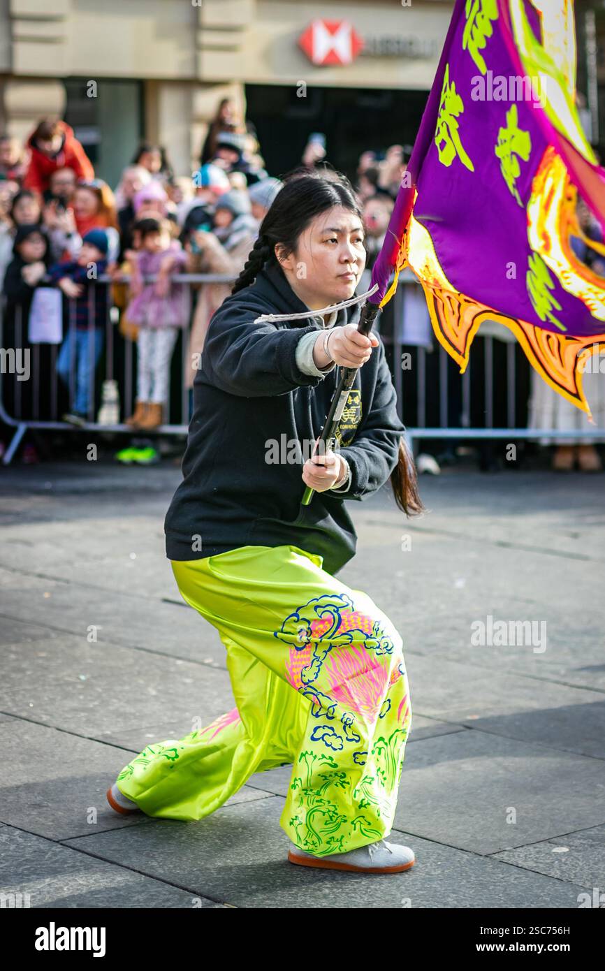 young asian woman in costume waving traditional banner flag at Chinese ...
