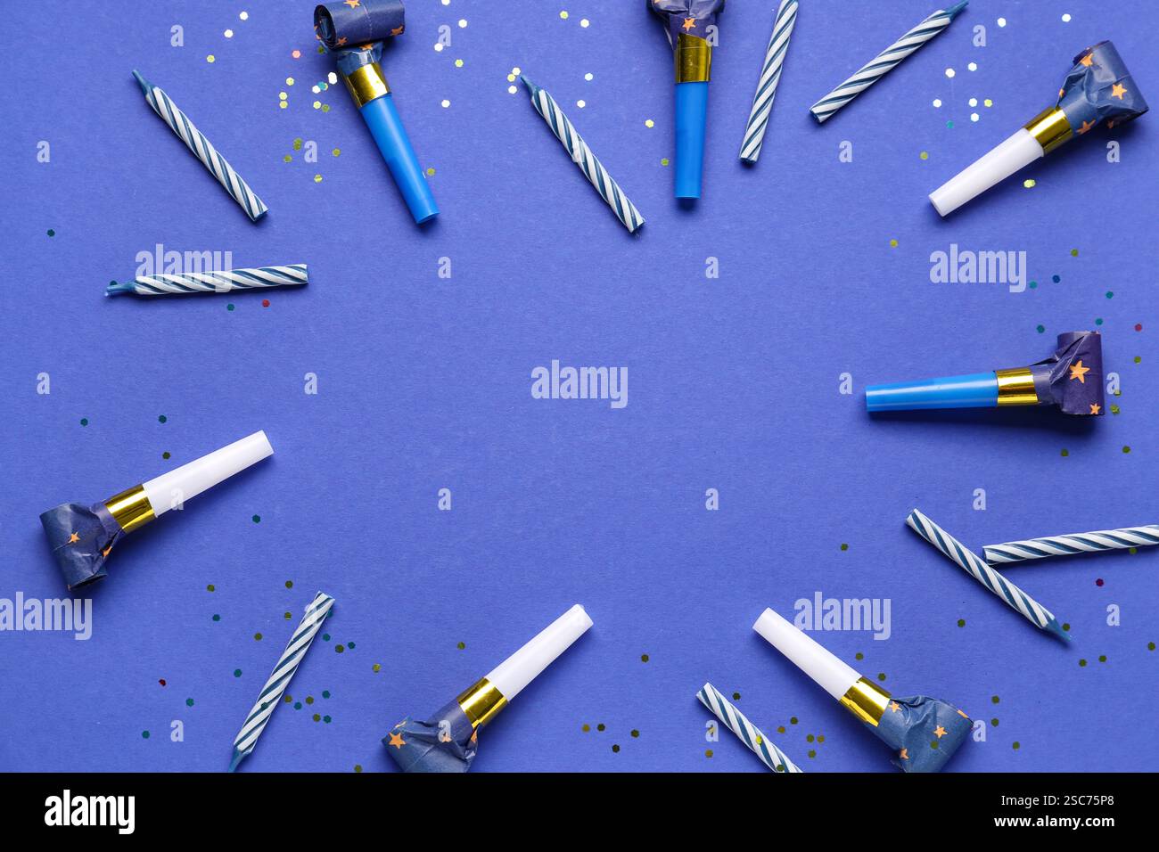 Frame made of whistles and candles for birthday party on dark blue ...