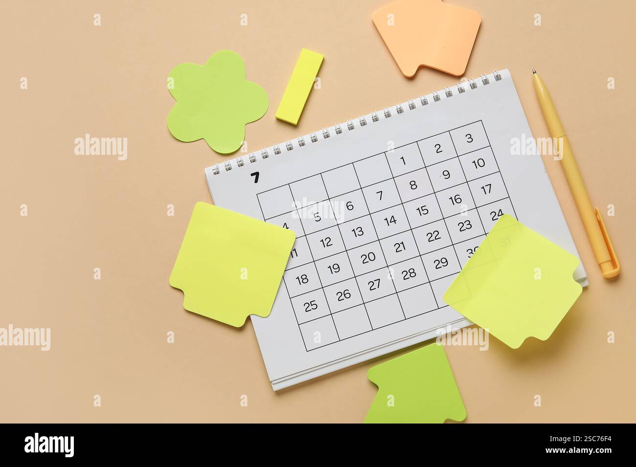 Calendar with office stationery on beige background Stock Photo - Alamy