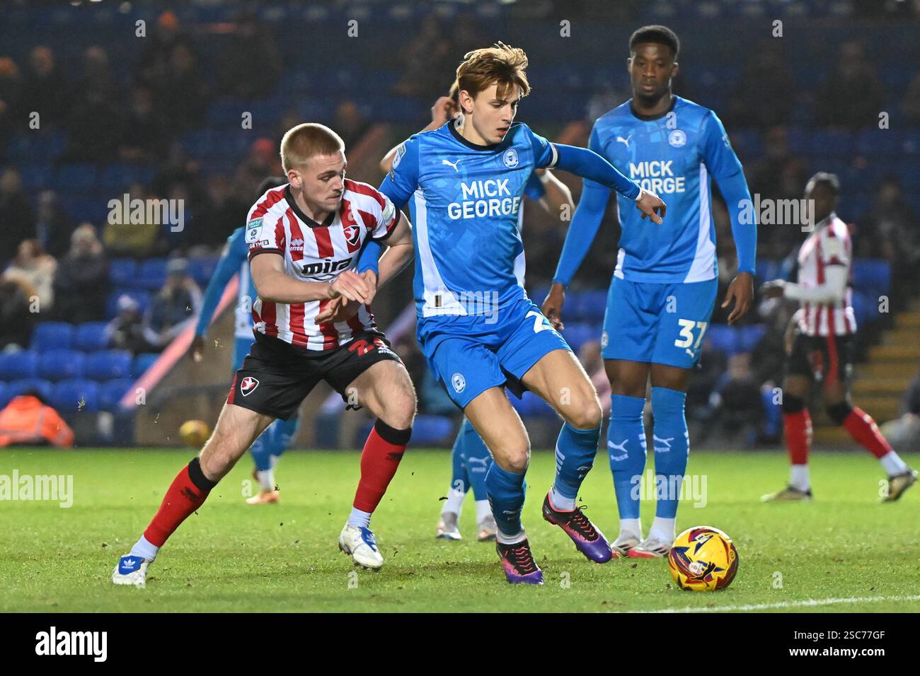 Hector Kyprianou (22 Peterborough United) holds off Tommy Backwell (26 ...