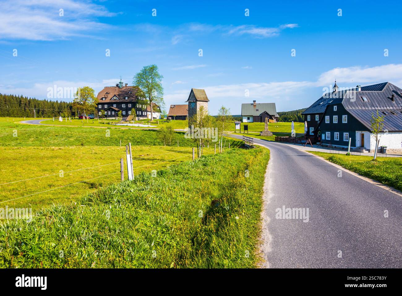 Road to Jizerka village with traditional mountain houses and ...