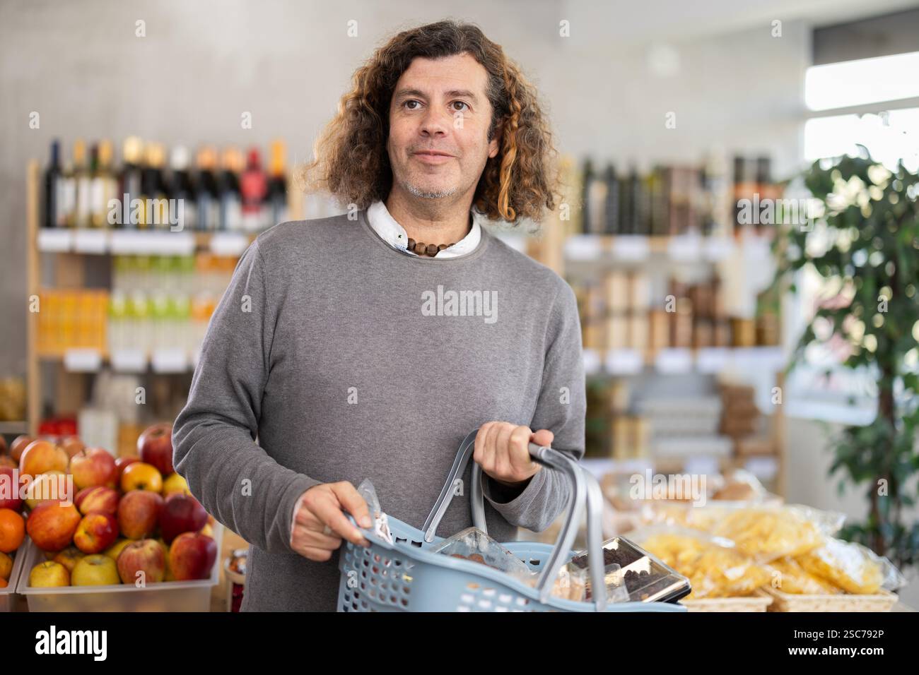 Adult man choosing food in grocery store Stock Photo - Alamy