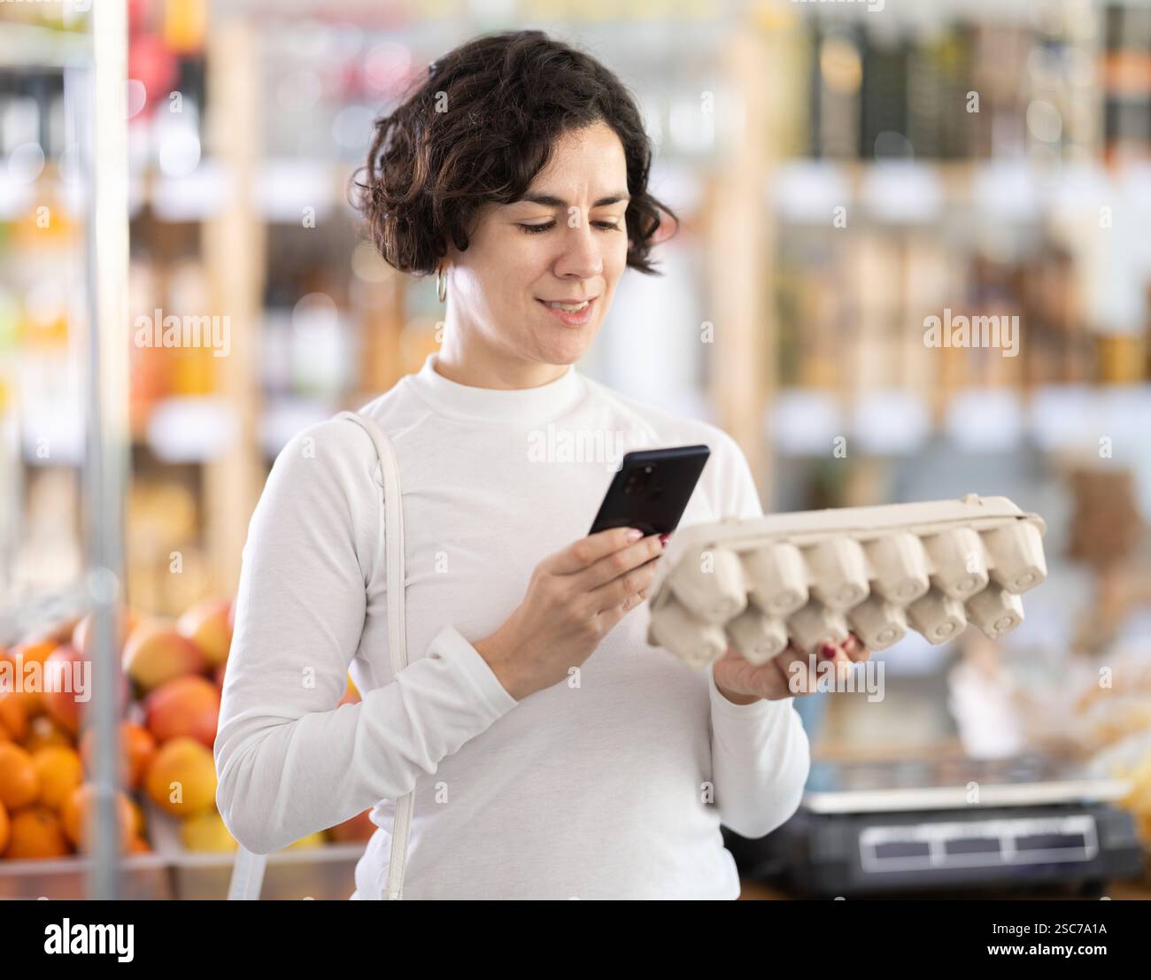 Woman get acquainted with food, scan QR code, take reading eggs label ...