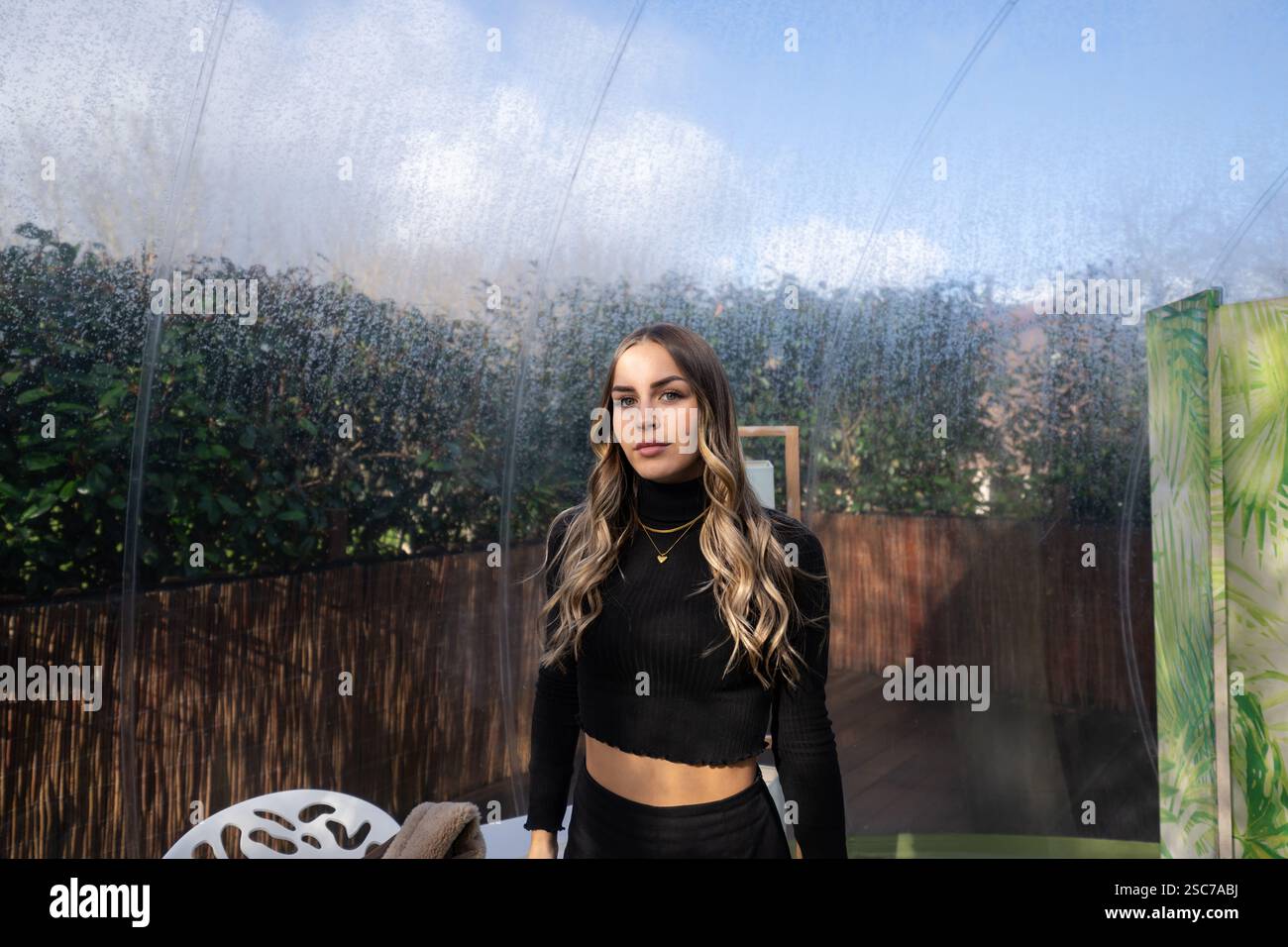 Young stylish influencer posing in a transparent dome restaurant with ...