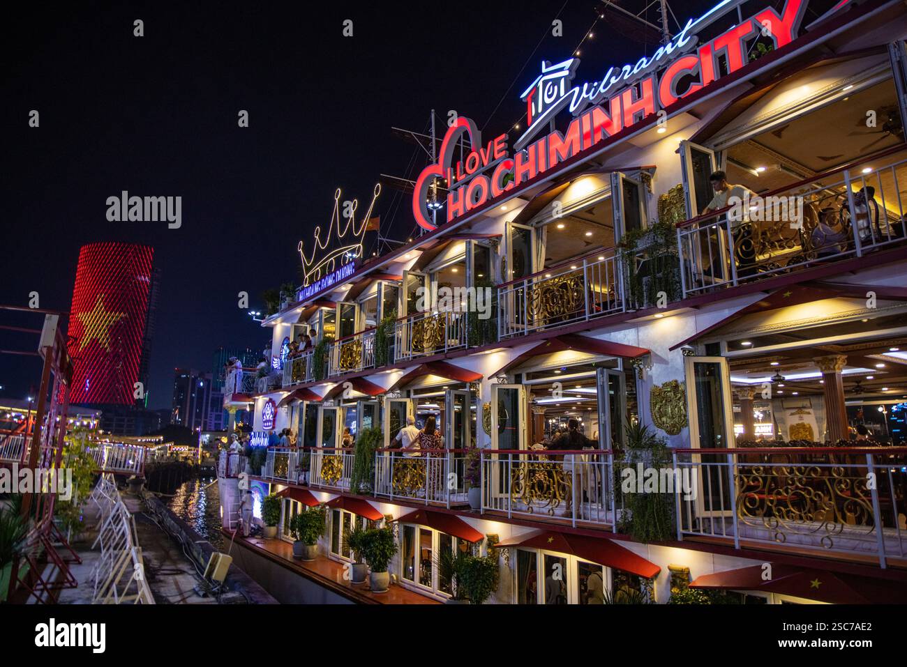 The illuminated dinner cruise boat Indochine approaches the pier on the ...