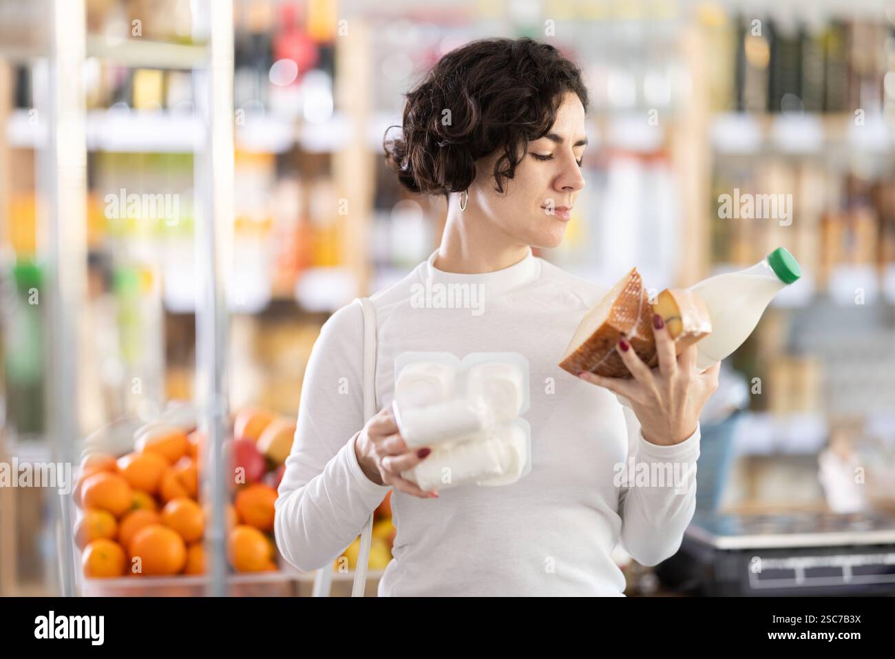 Woman picked up lot of varied food, and with armful of groceries, they ...
