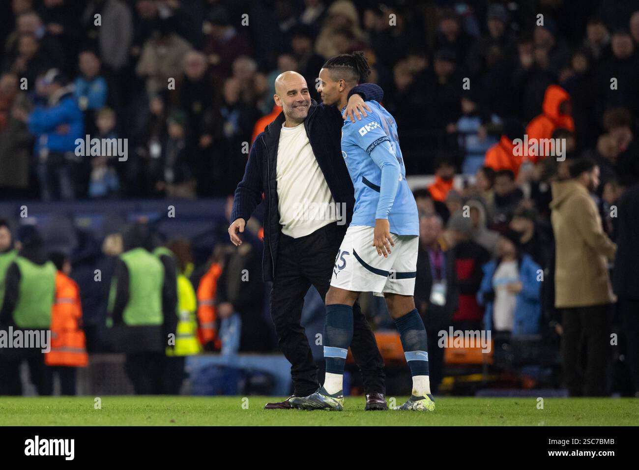Pep Guardiola, Manchester City manager, talks to Manuel Akanji ...