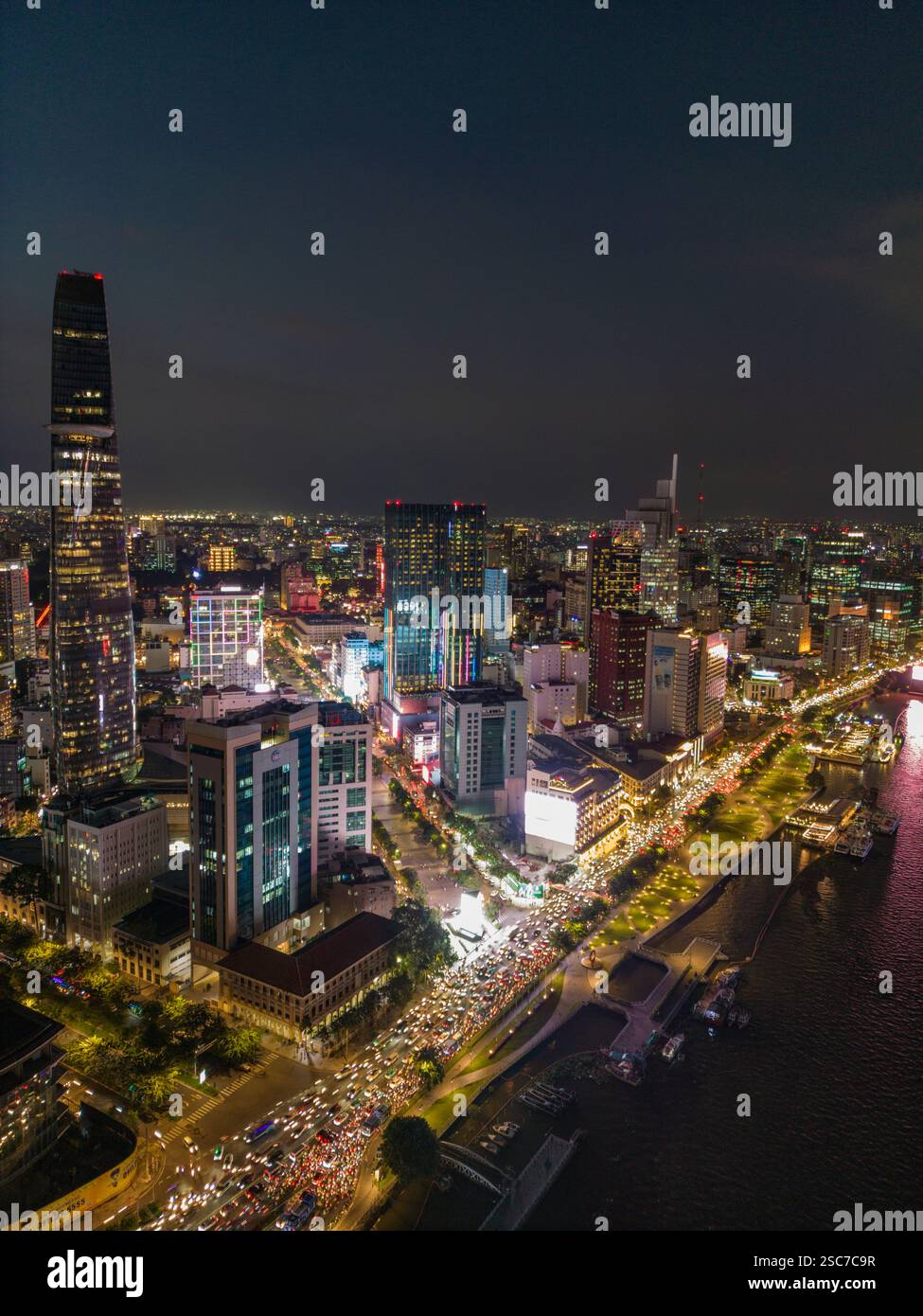Aerial view of rush hour traffic along Saigon River with skyscrapers in ...