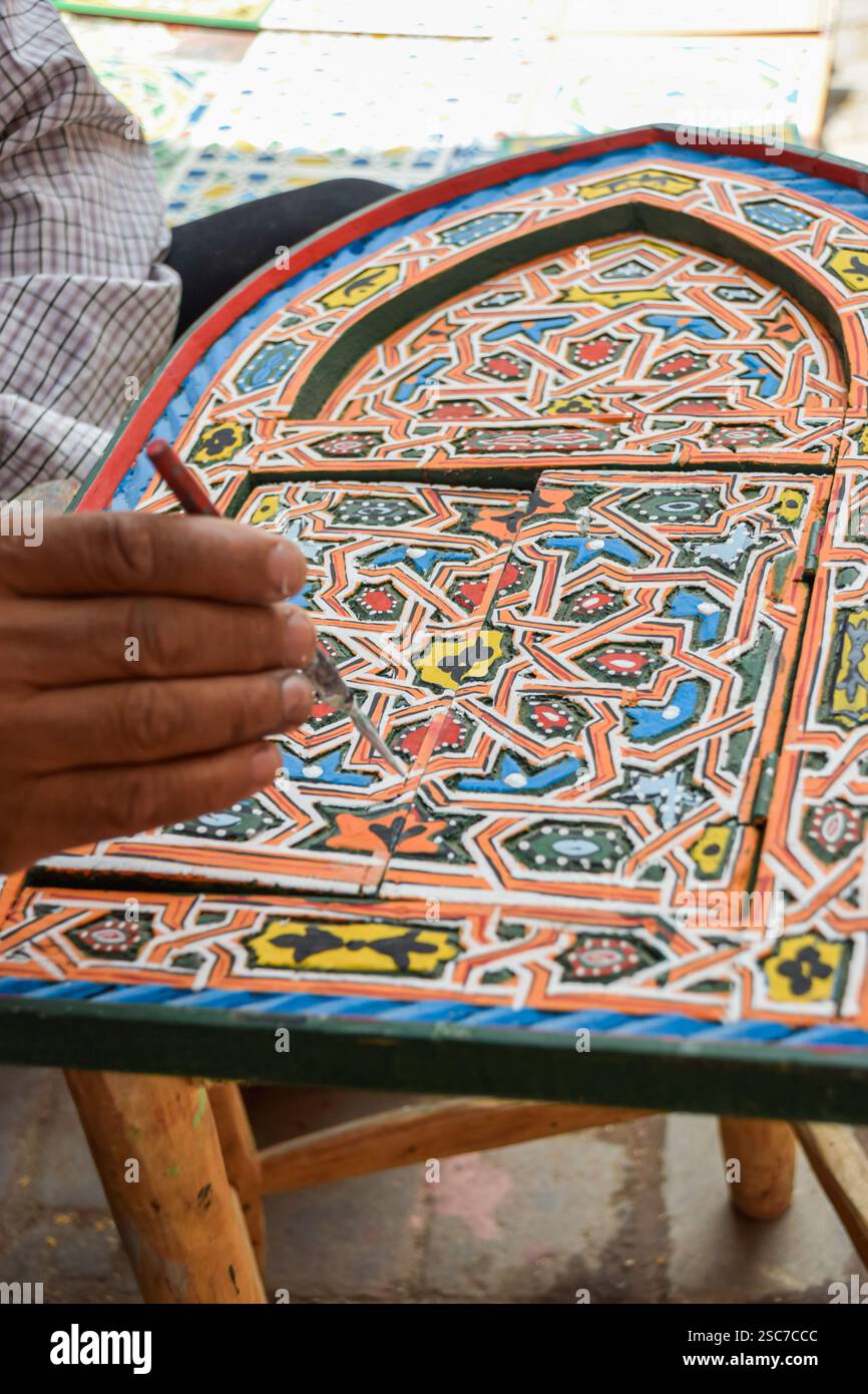 Hand painting in wooden decorative window in craft shop, Marrakech ...