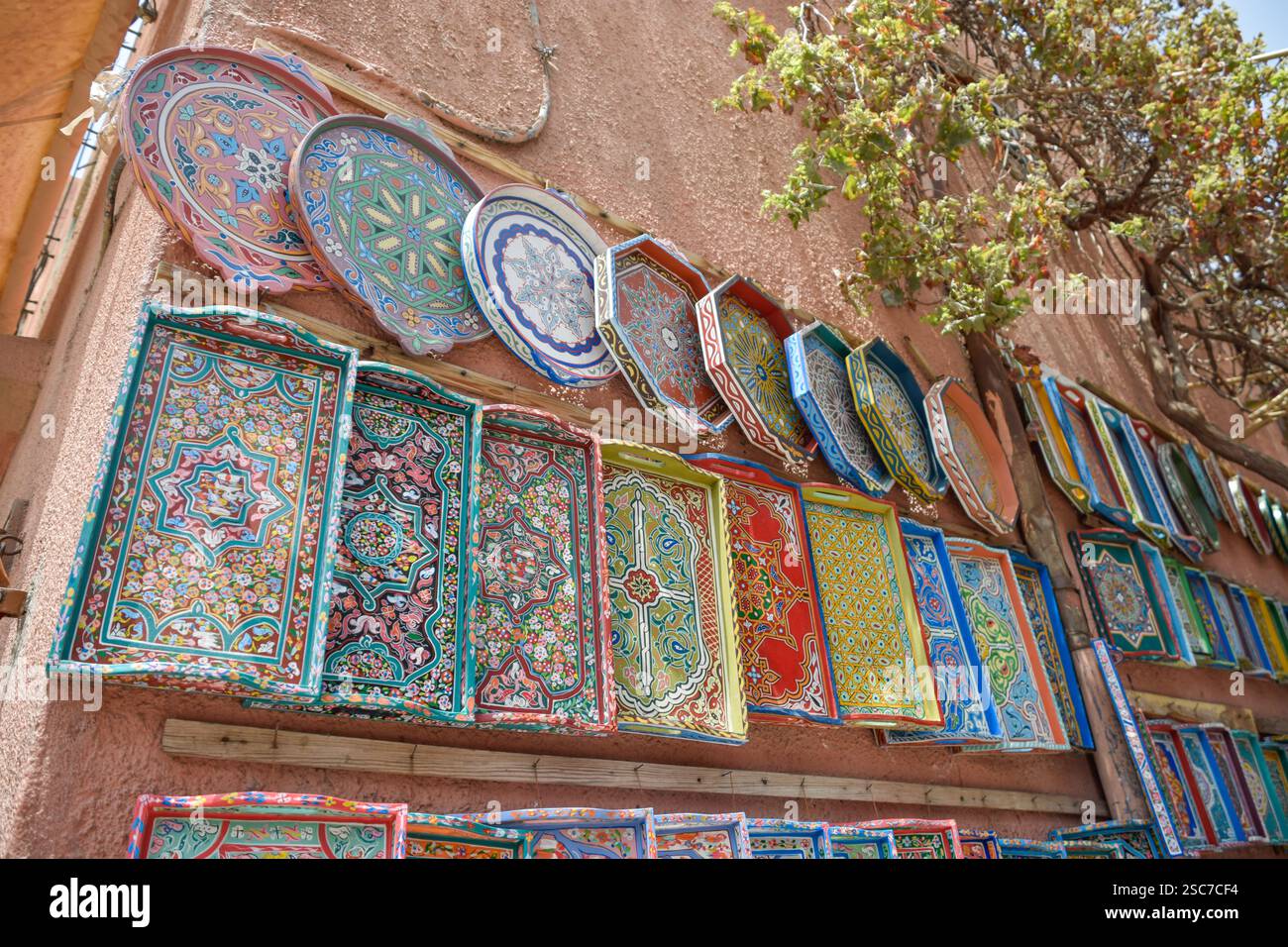 Colorful Hand-painted wooden trays and plates displayed in craft shop ...