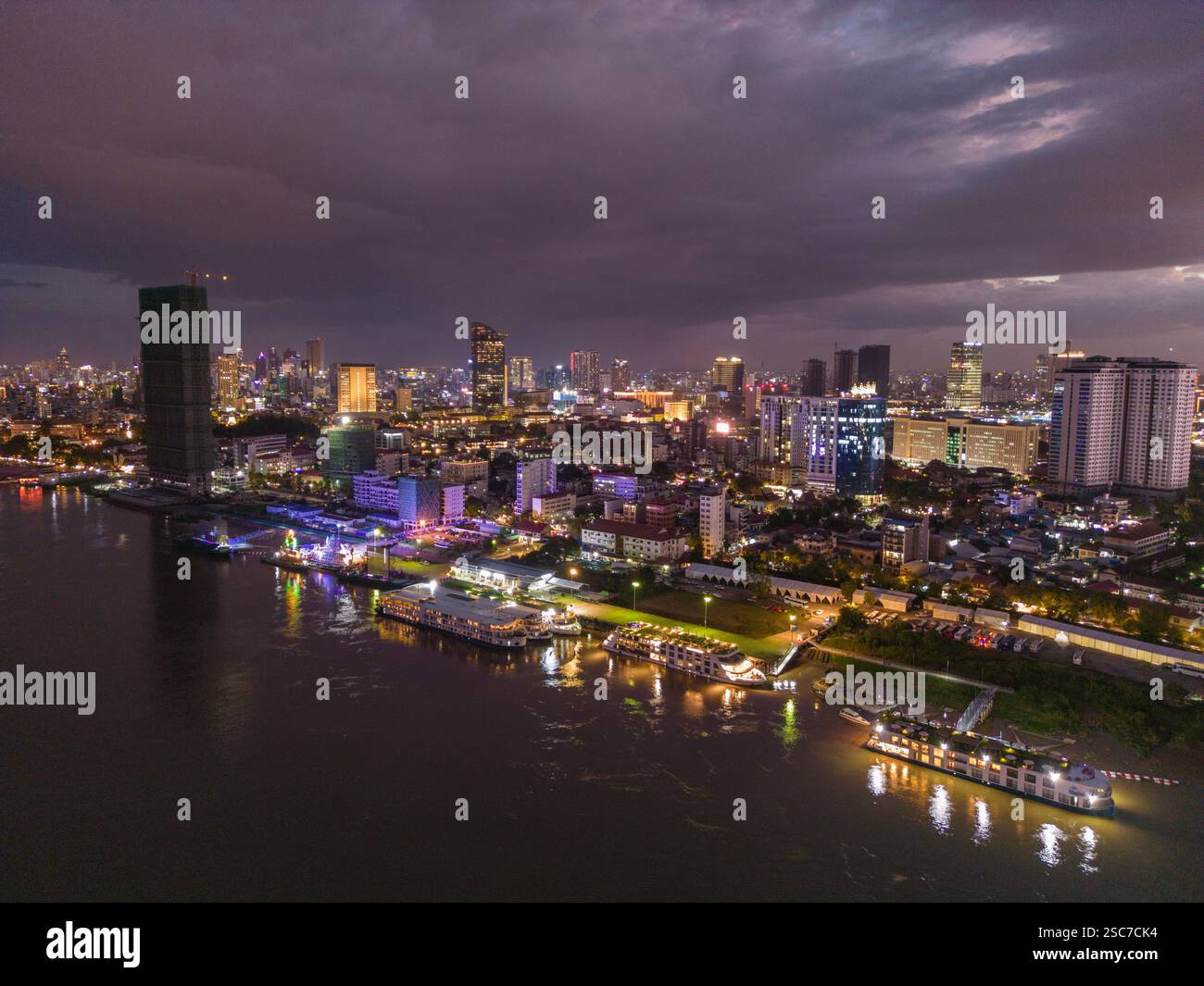 Aerial view of river cruise ships anchored on Tonle Sap River with city ...