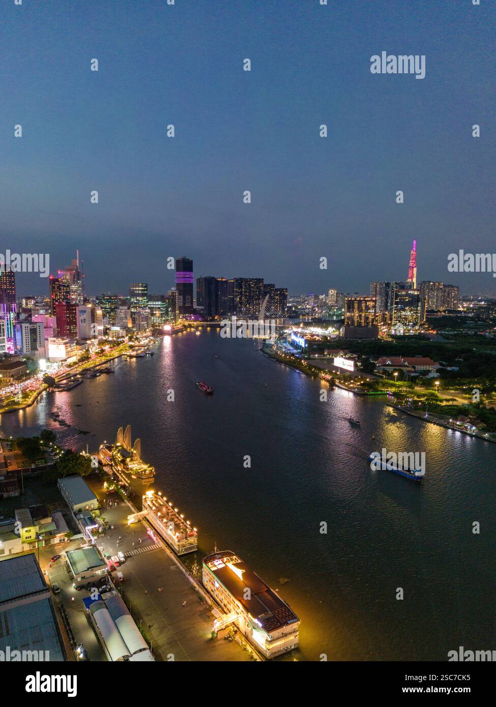 Aerial view of illuminated tourist tour boats along Saigon River with ...