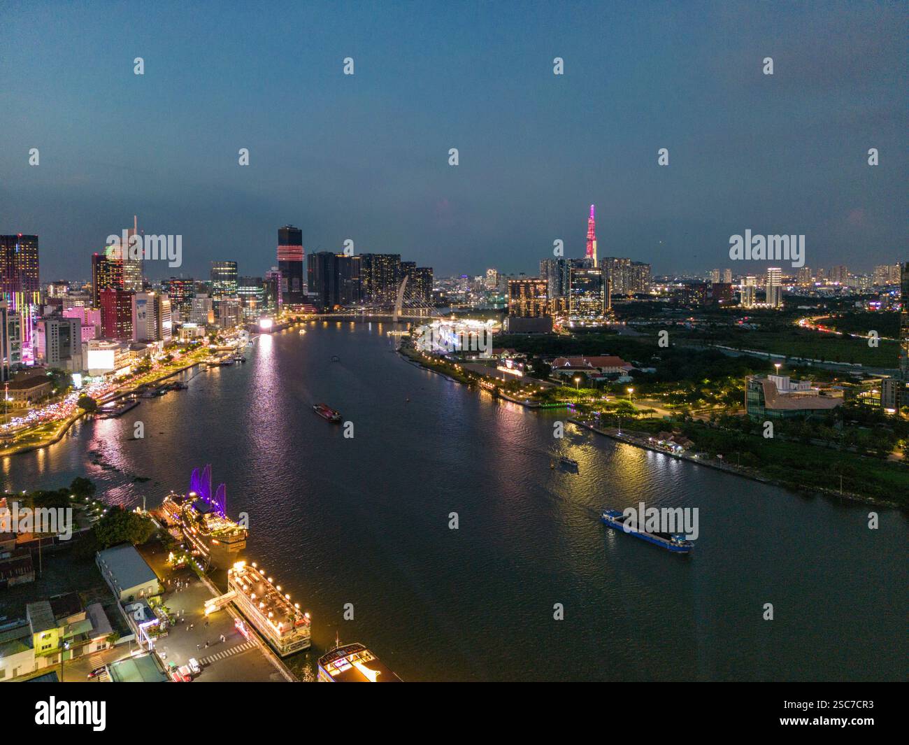 Aerial view of illuminated tourist tour boats along Saigon River with ...