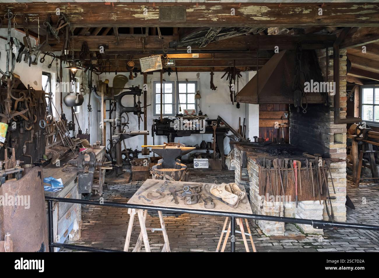 A vintage blacksmith workshop with tools, an anvil, and a forge Stock ...