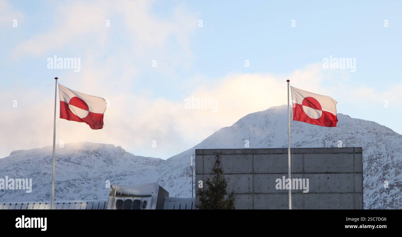 05 February 2025, Denmark, Nuuk: Two Greenlandic flags wave in the wind ...