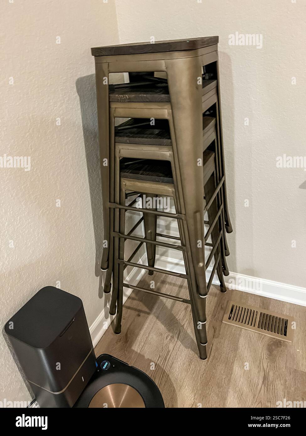 Stack of metal bar stools in corner Stock Photo - Alamy