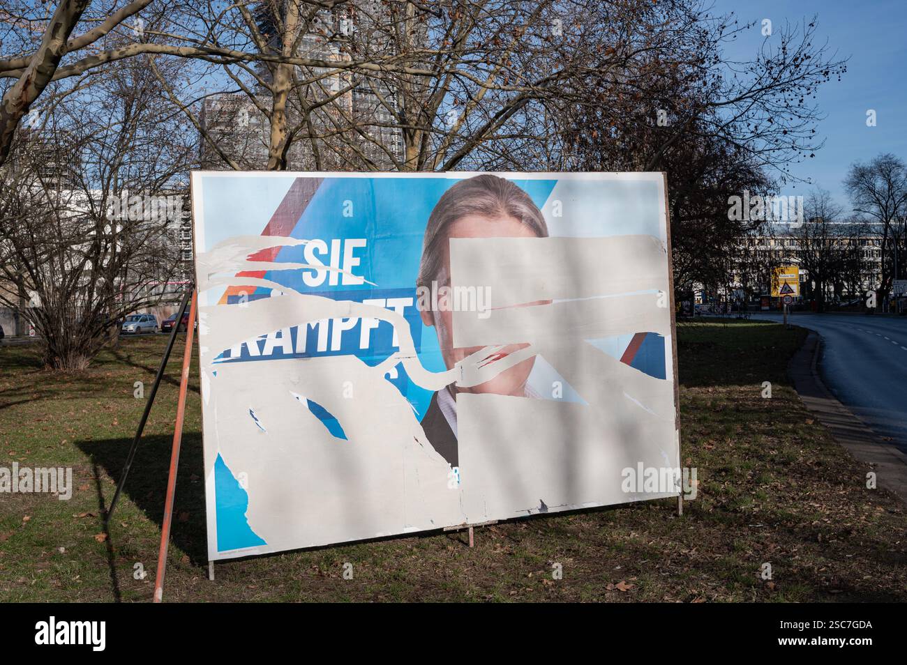 24.01.2025, Germany, Berlin, Berlin - A billboard with a partially torn ...
