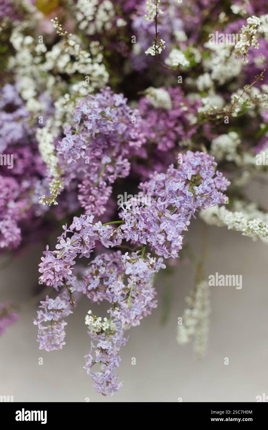A vibrant arrangement of lilac and white flowers displays a variety of ...