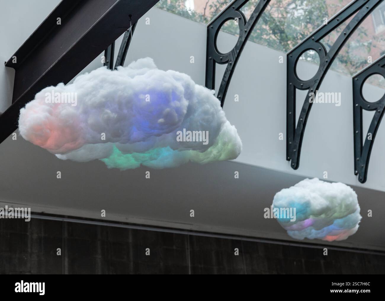 Two soft, fluffy cloud installations suspended from the ceiling ...