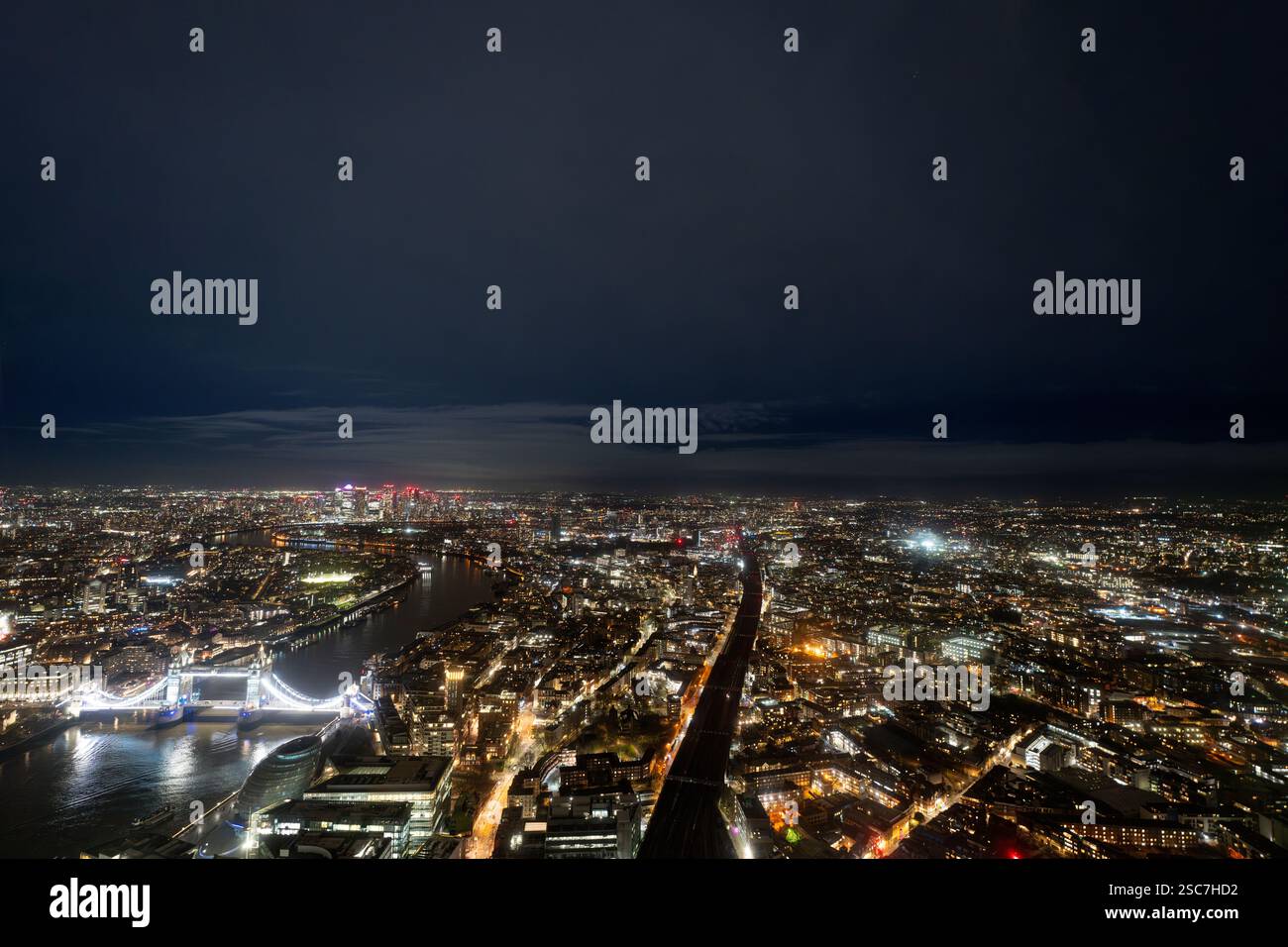 Night view of London, England, from a high vantage point. Tower Bridge ...