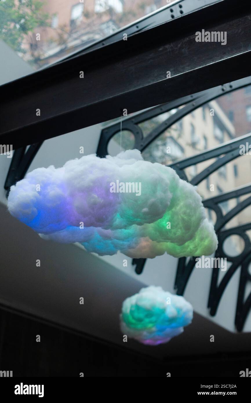 A whimsical cloud installation floats above in a modern interior ...