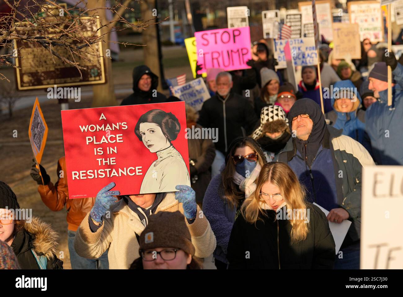 People carry signs and march in protest against Project 2025, President ...