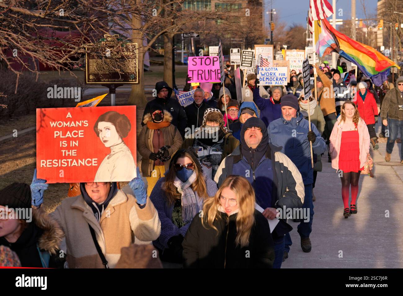 People carry signs and march in protest against Project 2025, President ...