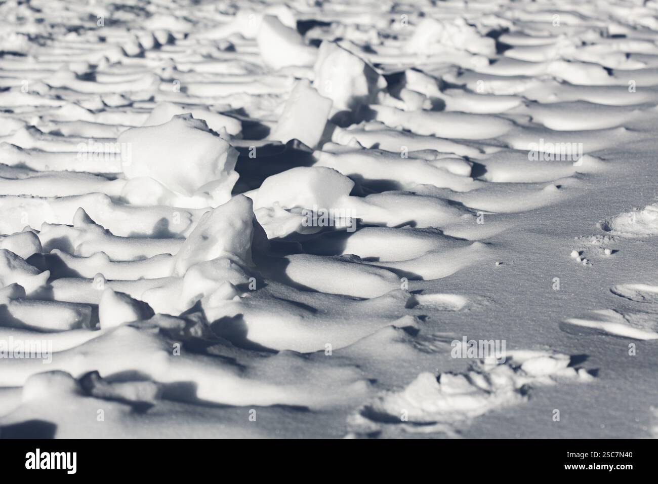 An image of a snowy surface featuring footprints and naturally formed ...