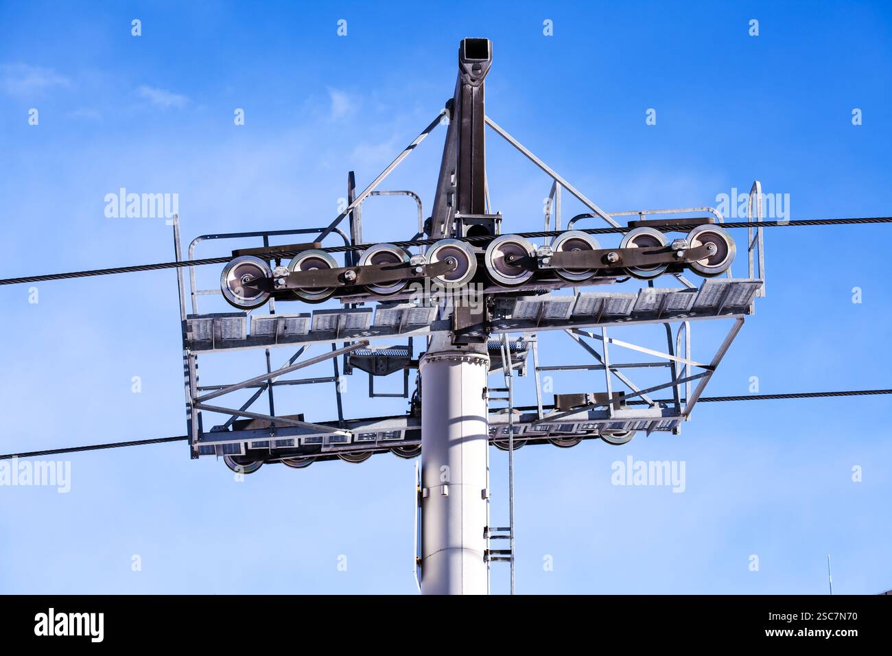 Close-up of a cable car support tower with intricate pulley mechanisms ...