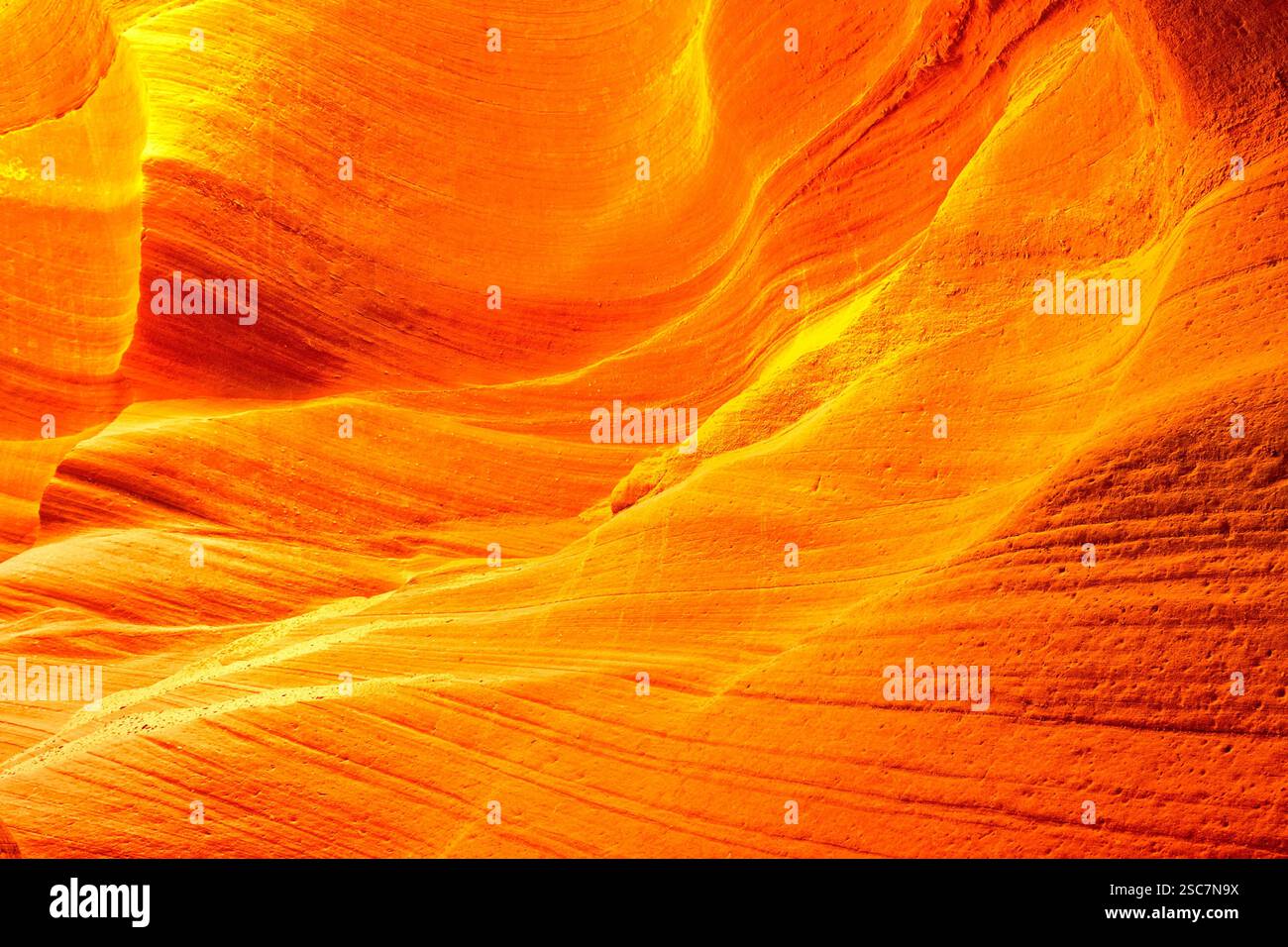 A large orange rock formation with a yellowish tint. The rock is very ...