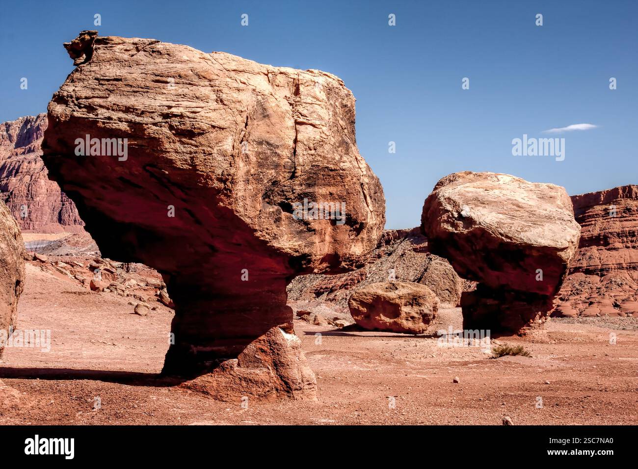 A large rock formation in the desert. The rocks are large and jagged ...