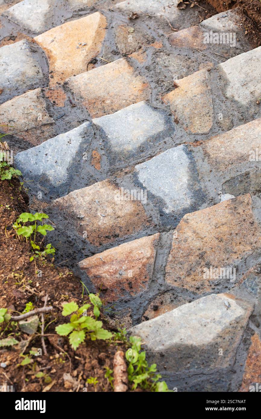 Close-up image of a rustic stone path featuring irregularly shaped ...