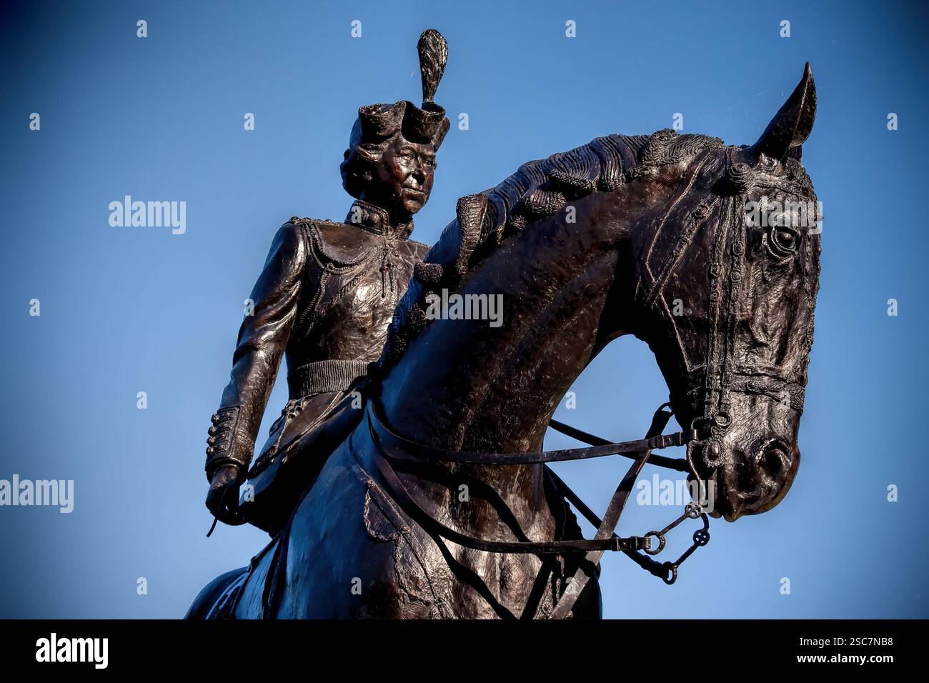 A statue of a man on a horse. The man is wearing a uniform and has a ...