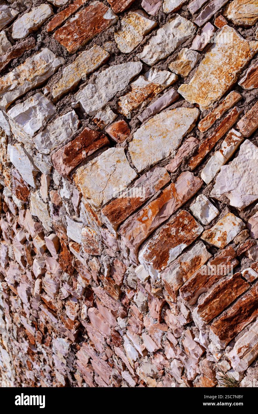 Rough stonework with earthy tones and diverse shapes, displaying an ...