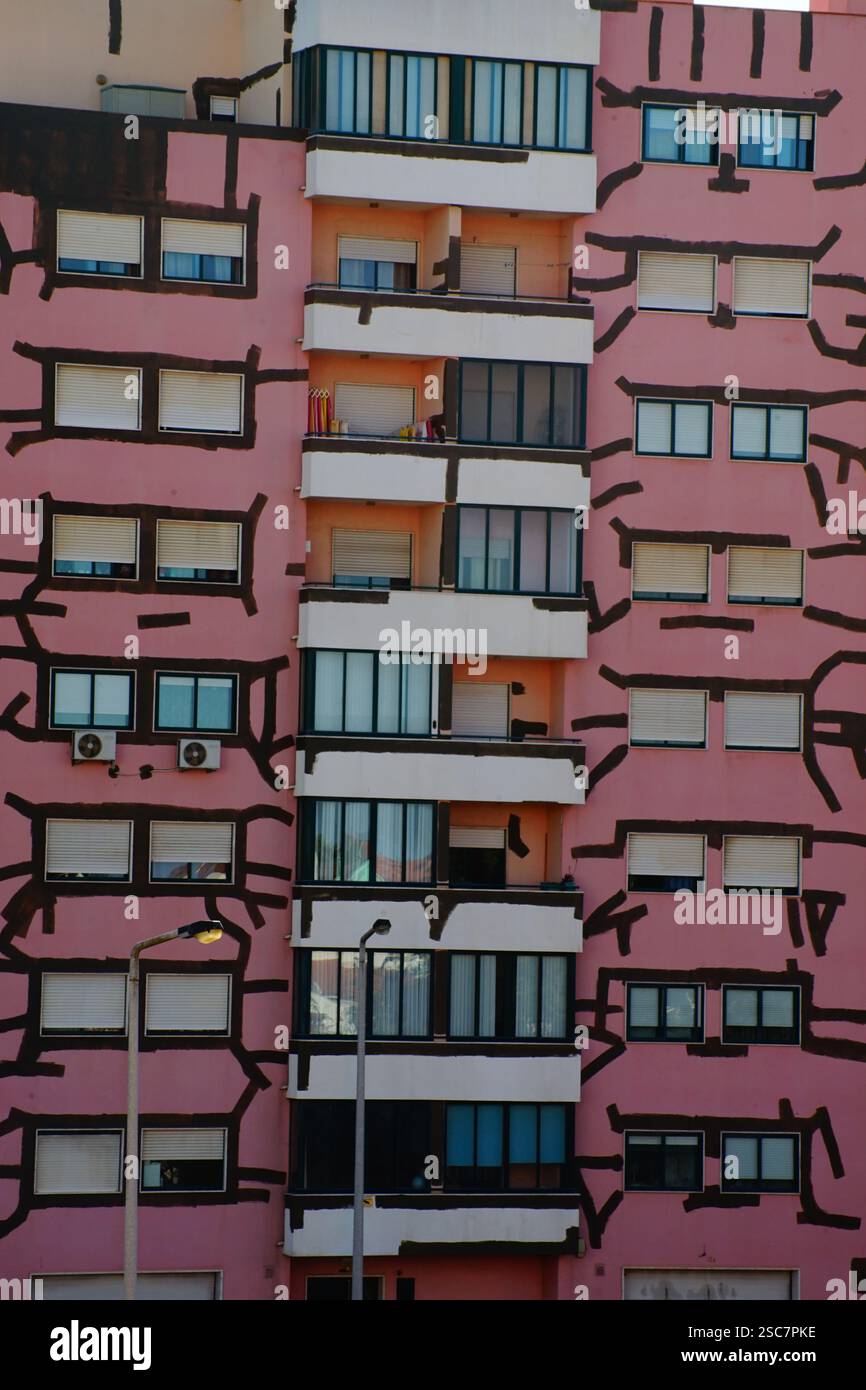 Pink residential building undergoing repair of cracks forming peculiar ...