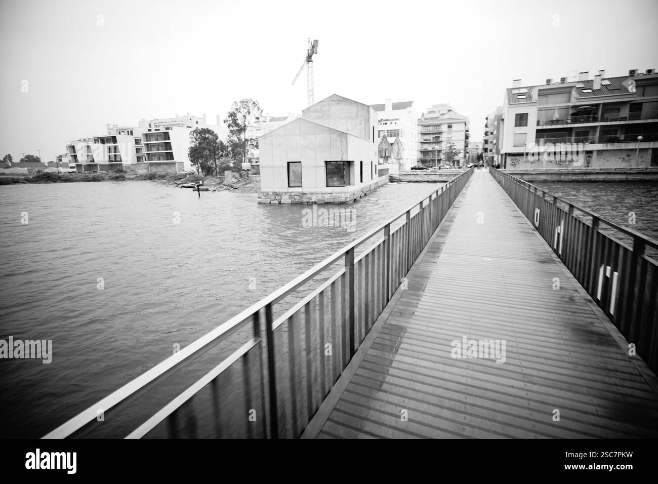 Black and white photograph of wooden walkway and building on the left ...