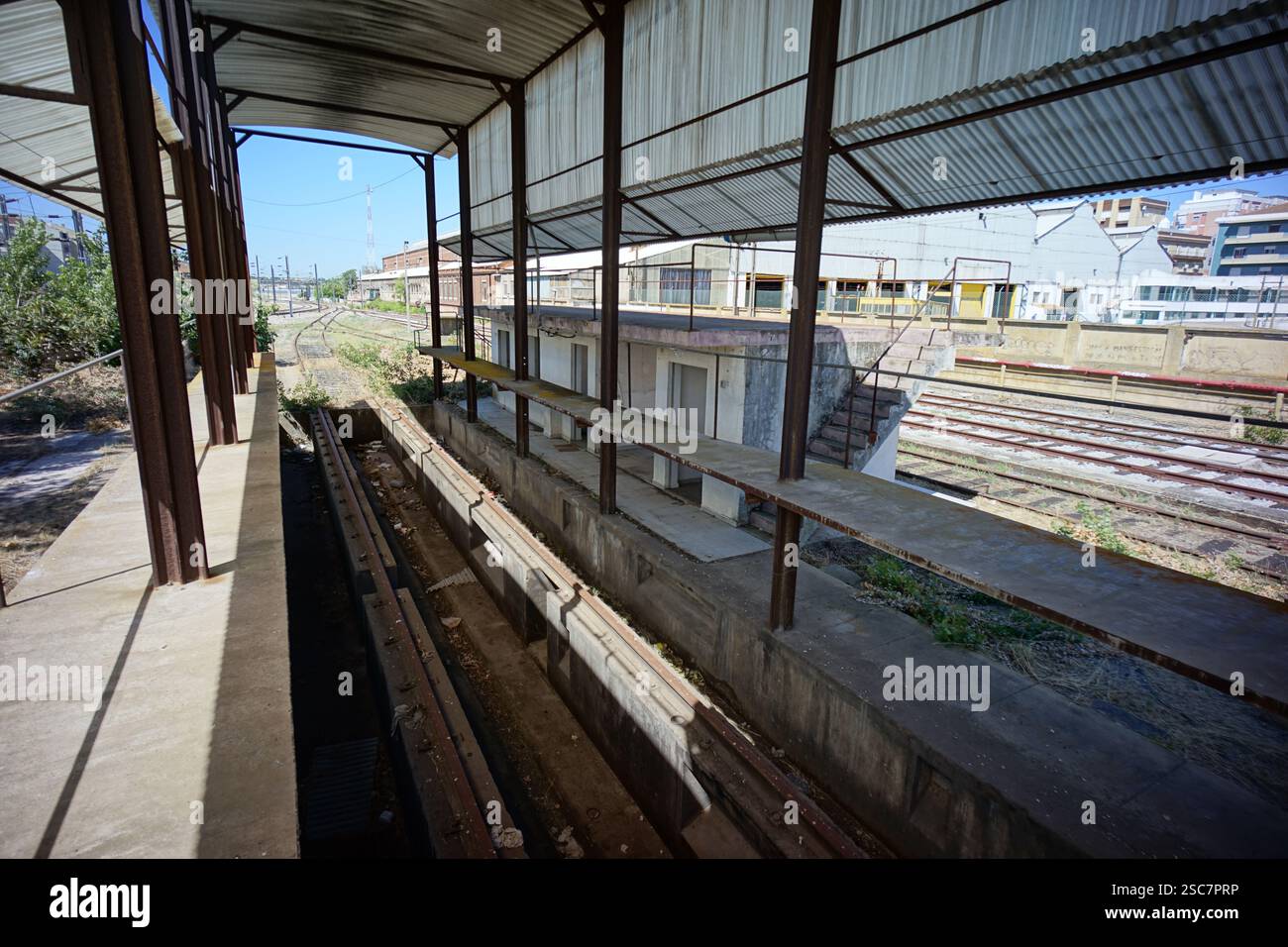 Train lines, in the background old train workshop Stock Photo - Alamy