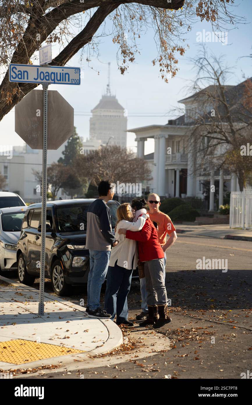 Group hugs on San Joaquin St. near a historic home in Fresno, CA ...