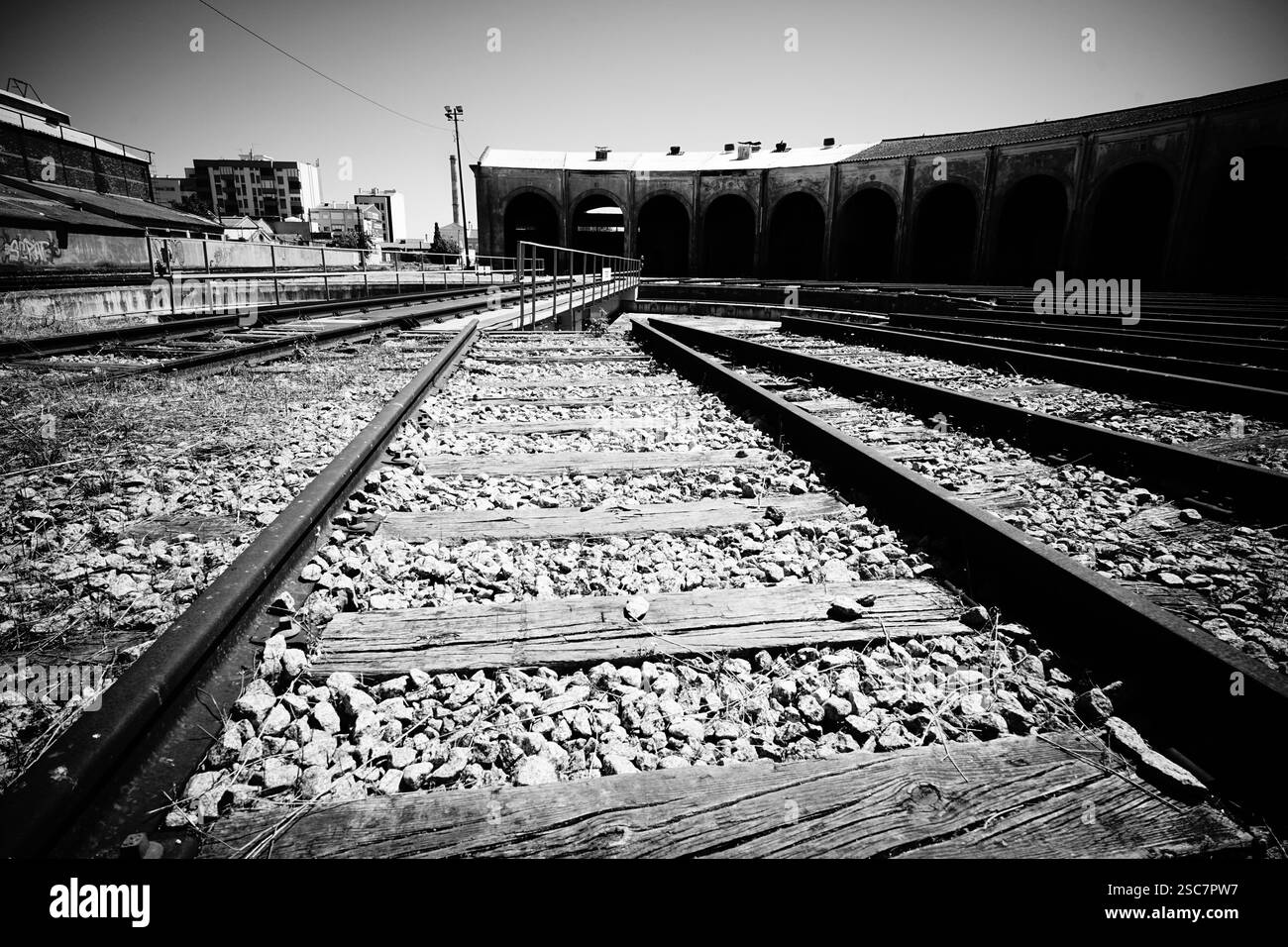 Train lines, in the background old train workshop Stock Photo - Alamy