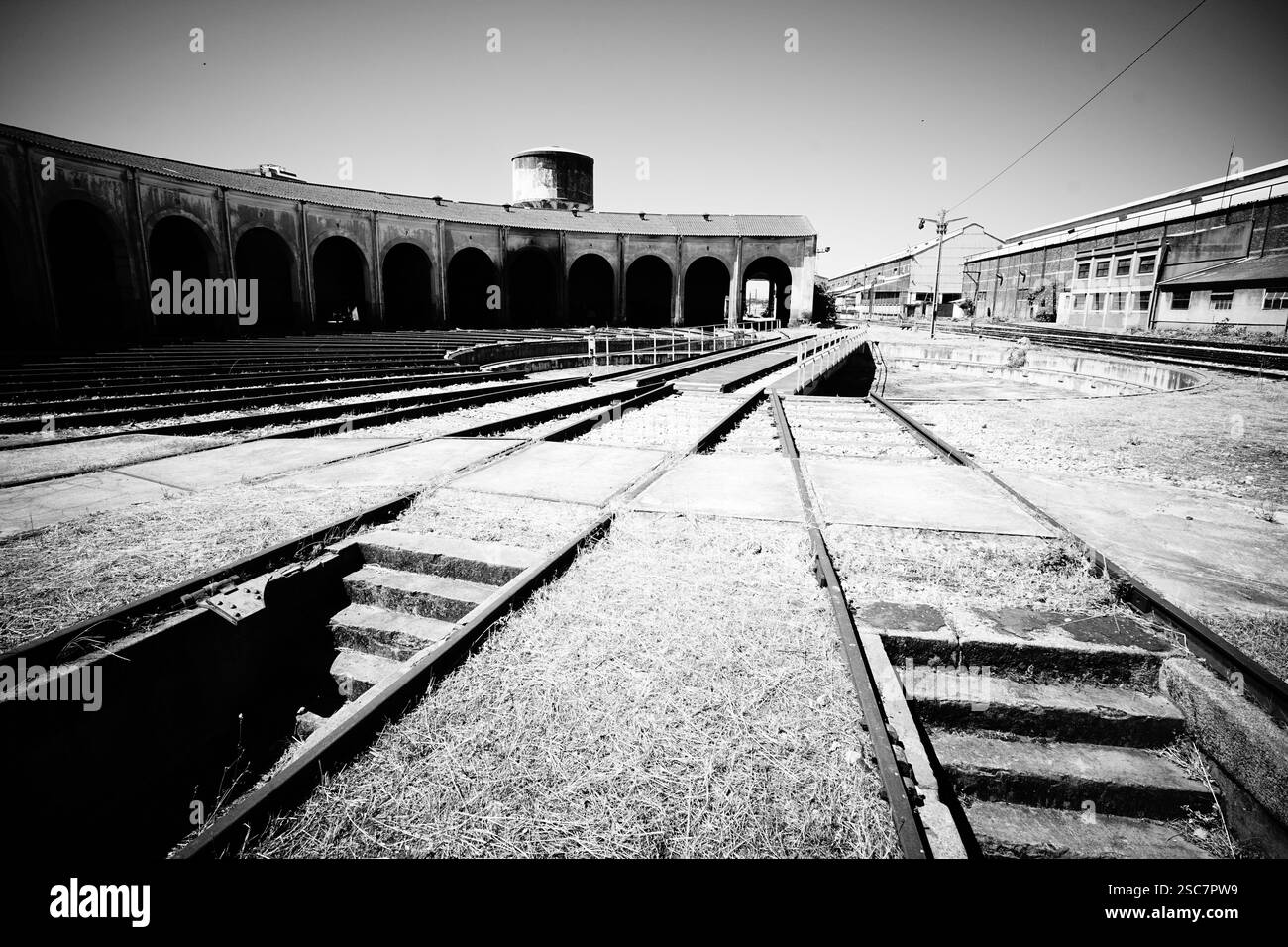 Train lines, in the background old train workshop Stock Photo - Alamy