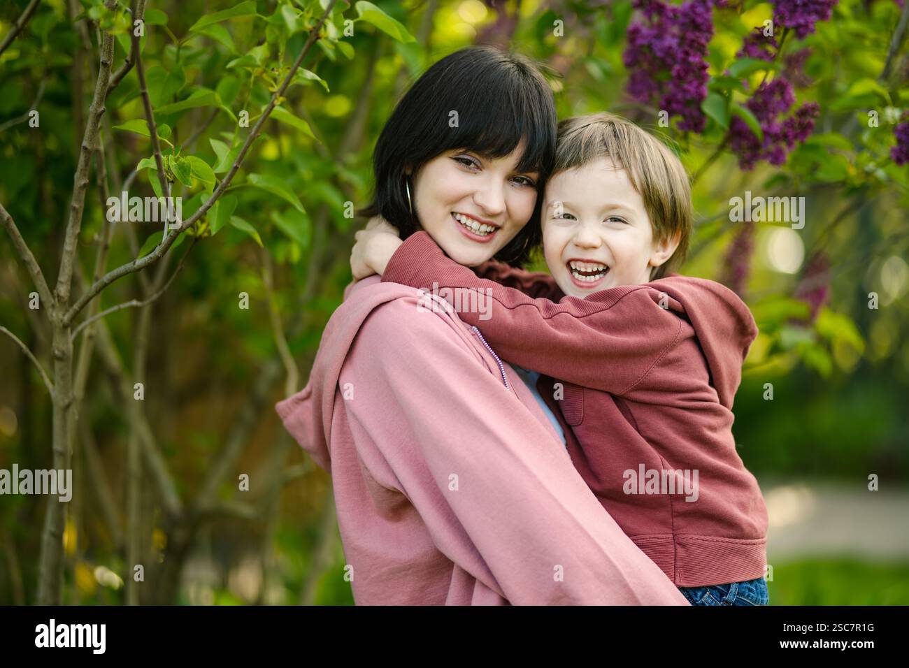 Cute big sister cuddling with her toddler brother. Adorable teenager ...